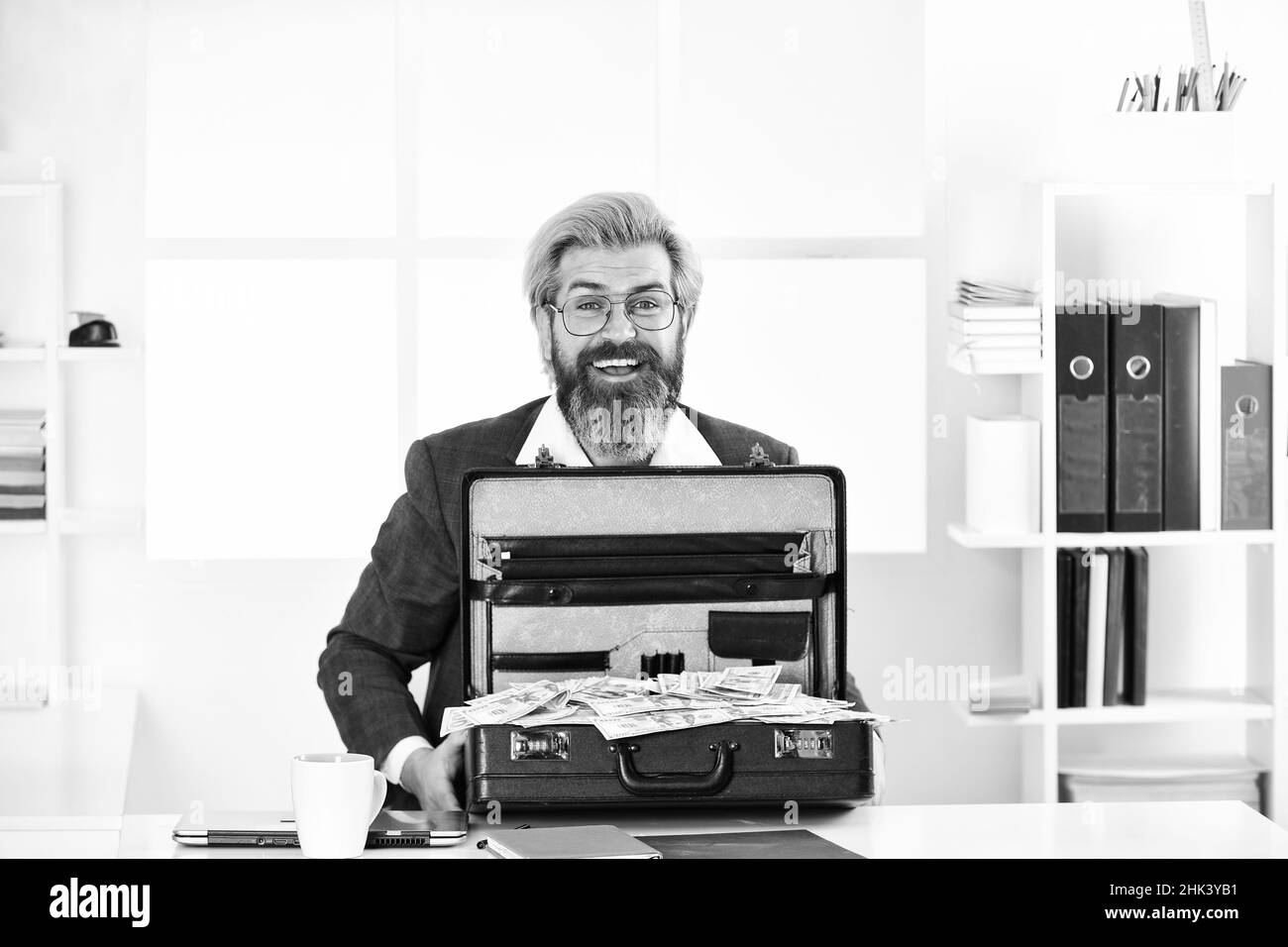 look at that. Businessman hand holding briefcase. suitcase with money ...