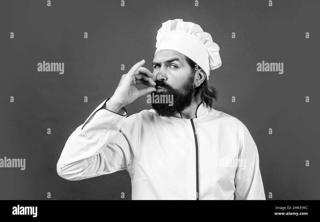 confident chef man with beard and moustache in cook uniform show sigh ...