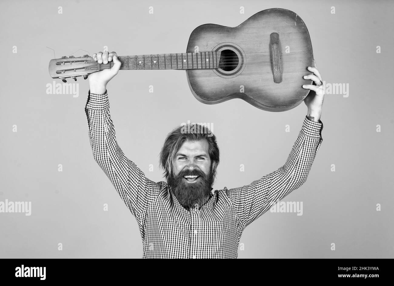 mature hipster musician with beard. brutal caucasian guy playing guitar ...