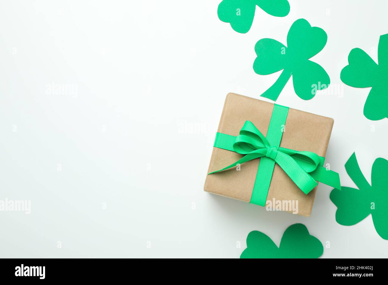 Clover leaves and gift box on white background Stock Photo - Alamy