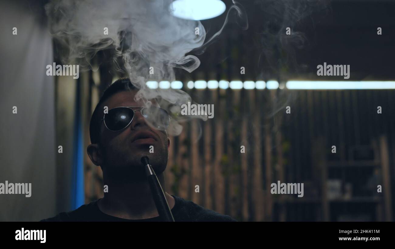 Arabic jordanian young man smokes a hookah Stock Photo - Alamy