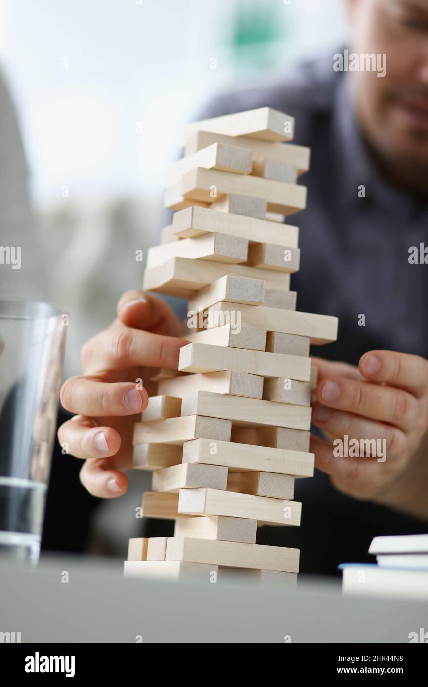 Man removing wooden block hi-res stock photography and images - Alamy
