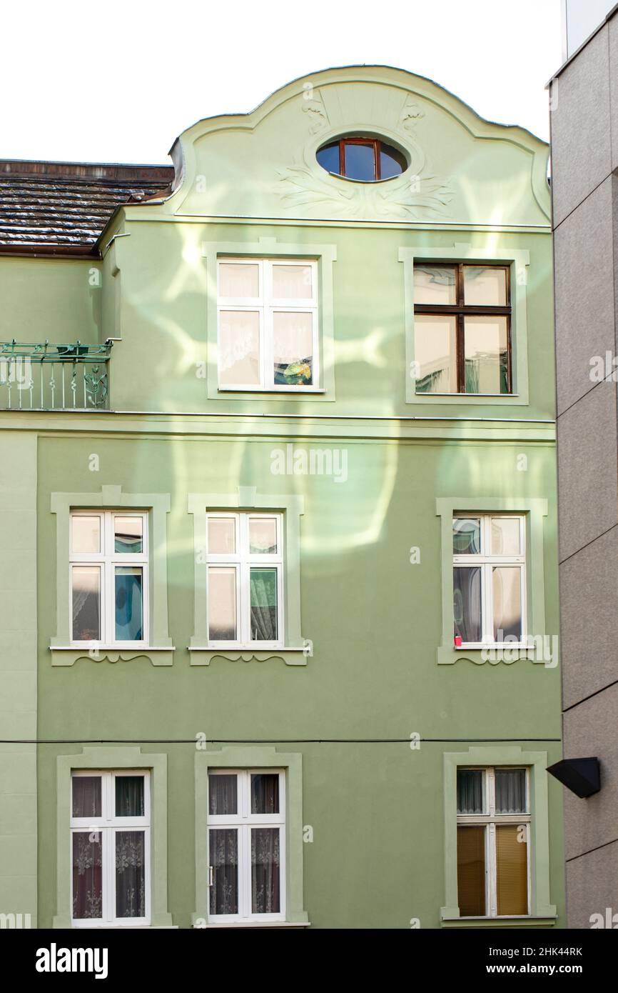Glare and window reflections on the facade of an old tenement house ...