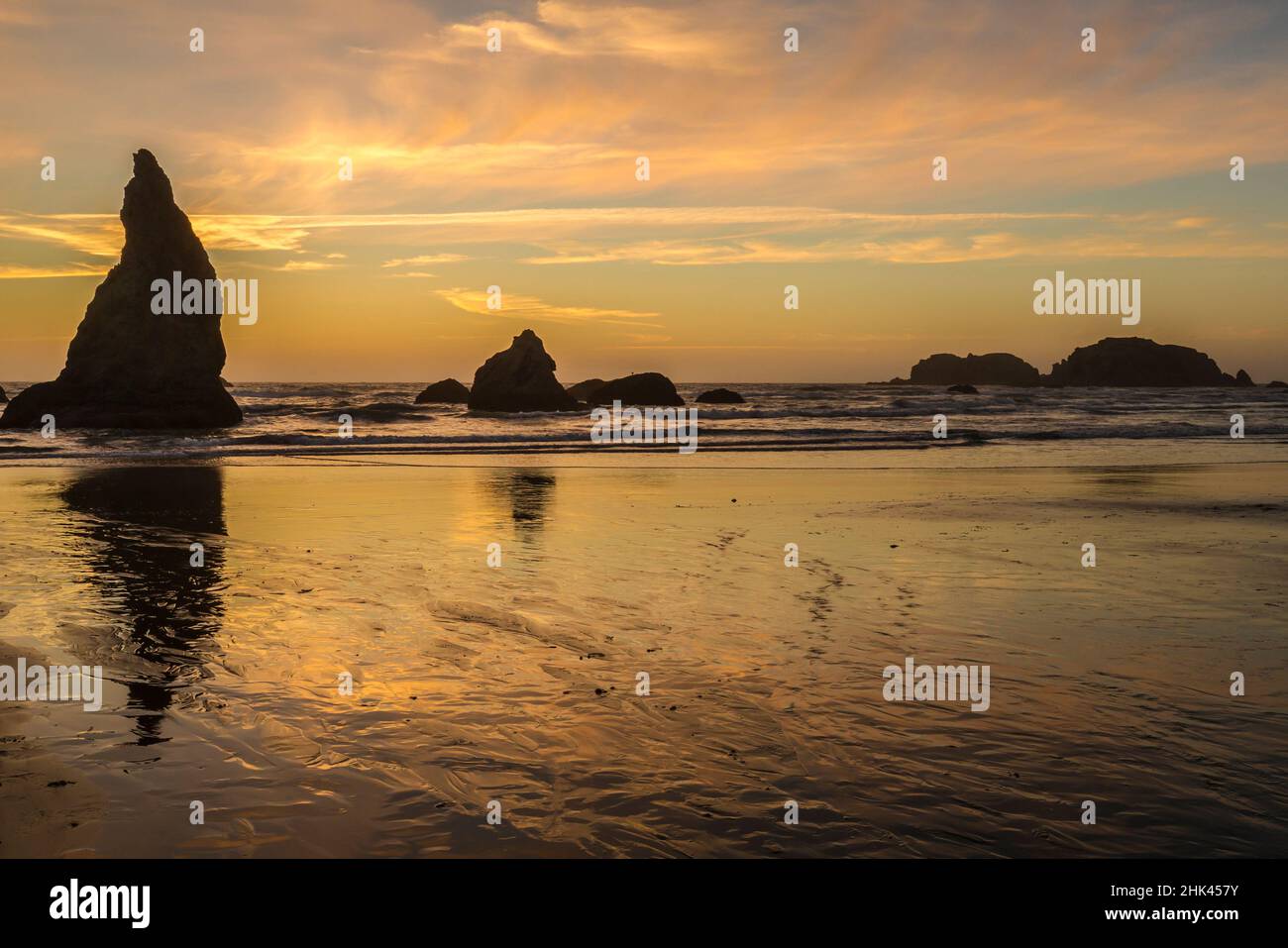 USA, Oregon, Bandon Beach. Wizard's Hat and other formations at sunset ...