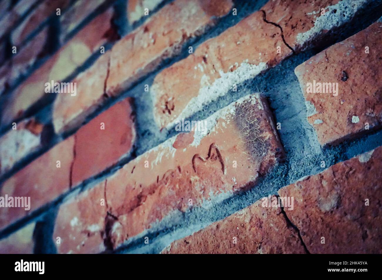 Vintage, cracked bricks with letters on a wall Stock Photo - Alamy