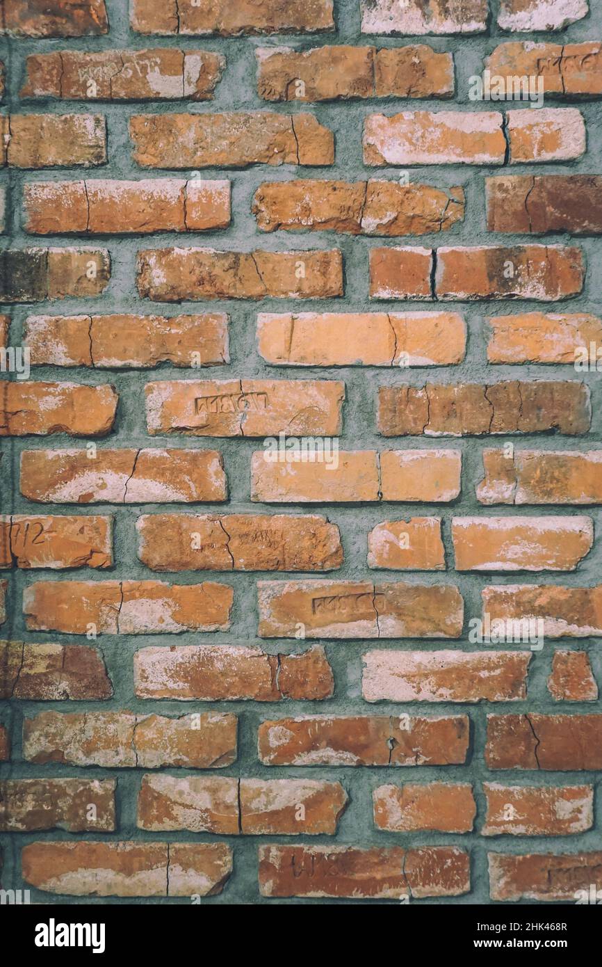 Vintage, cracked bricks with letters on a wall Stock Photo - Alamy