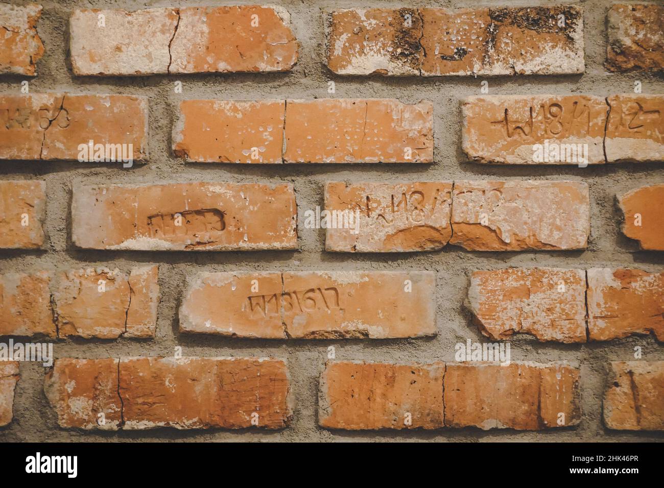 Vintage, cracked bricks with letters on a wall Stock Photo - Alamy