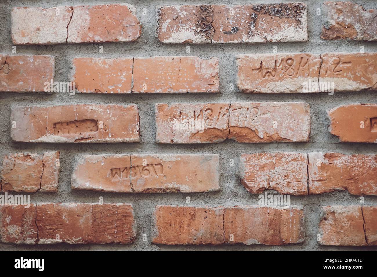 Vintage, cracked bricks with letters on a wall Stock Photo - Alamy