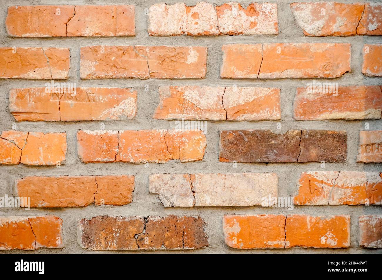 Vintage, cracked bricks with letters on a wall Stock Photo - Alamy