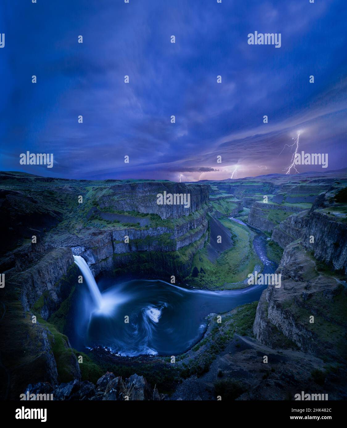 USA. Washington State. Palouse Falls at dusk with an approaching ...