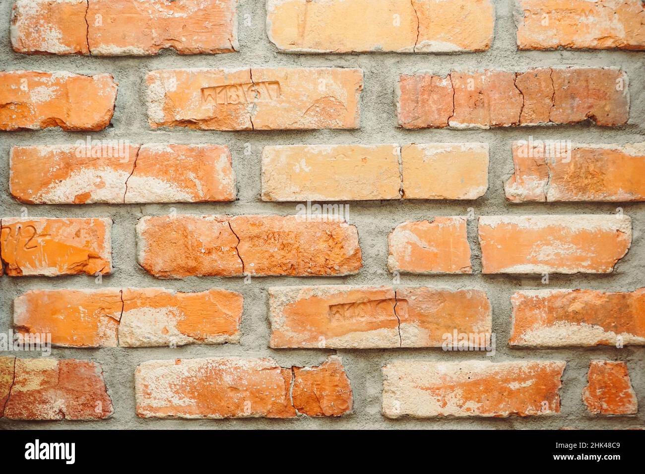 Vintage, cracked bricks with letters on a wall Stock Photo - Alamy