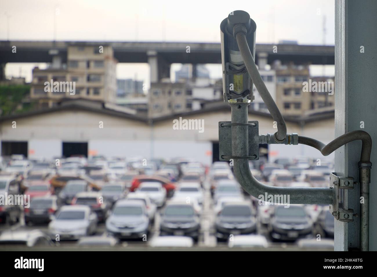 Rear view of CCTV cameras to monitor group of vehicles on park in the ...