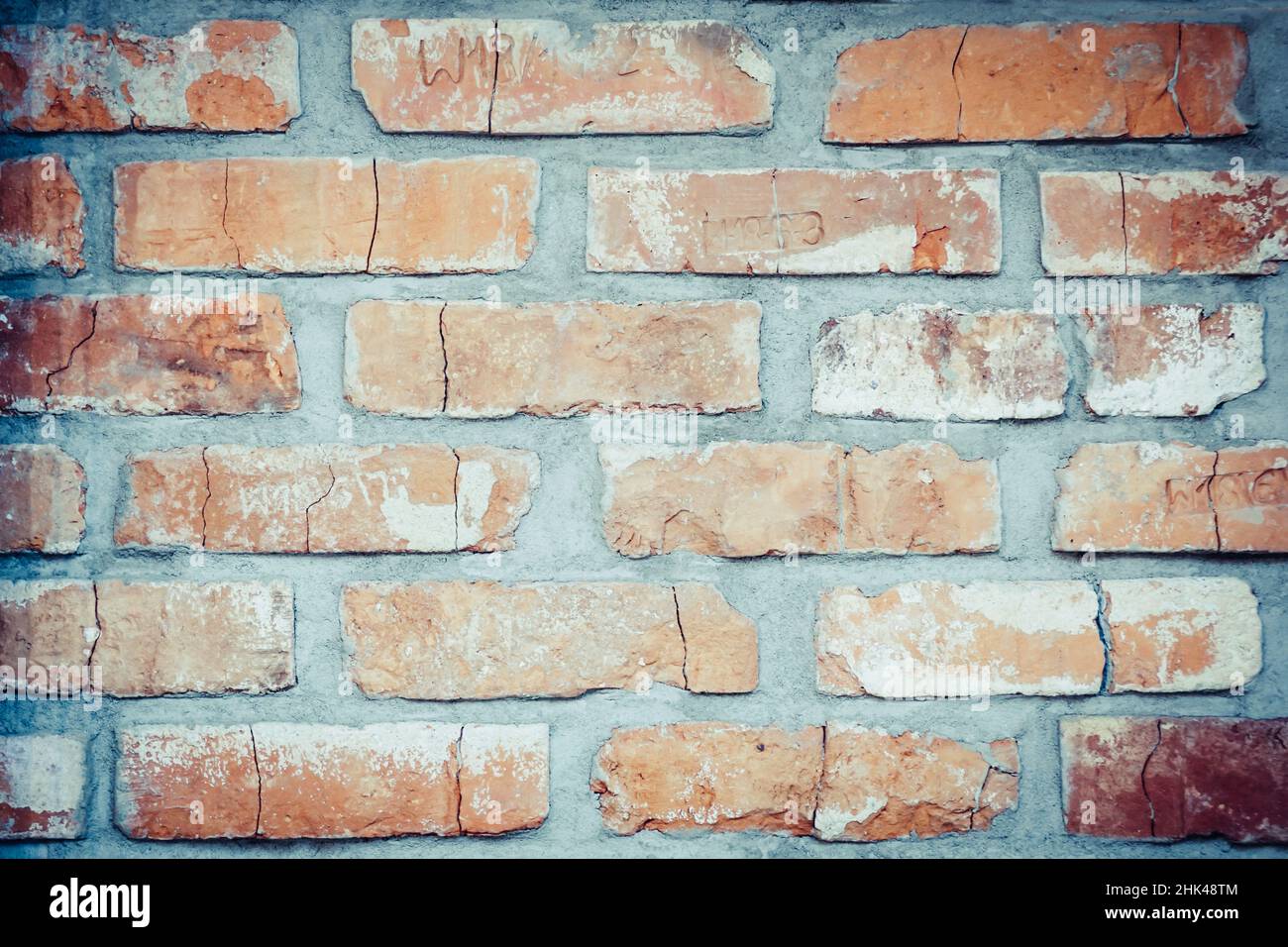 Vintage, cracked bricks with letters on a wall Stock Photo - Alamy