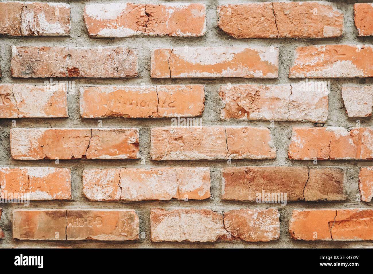 Vintage, cracked bricks with letters on a wall Stock Photo - Alamy