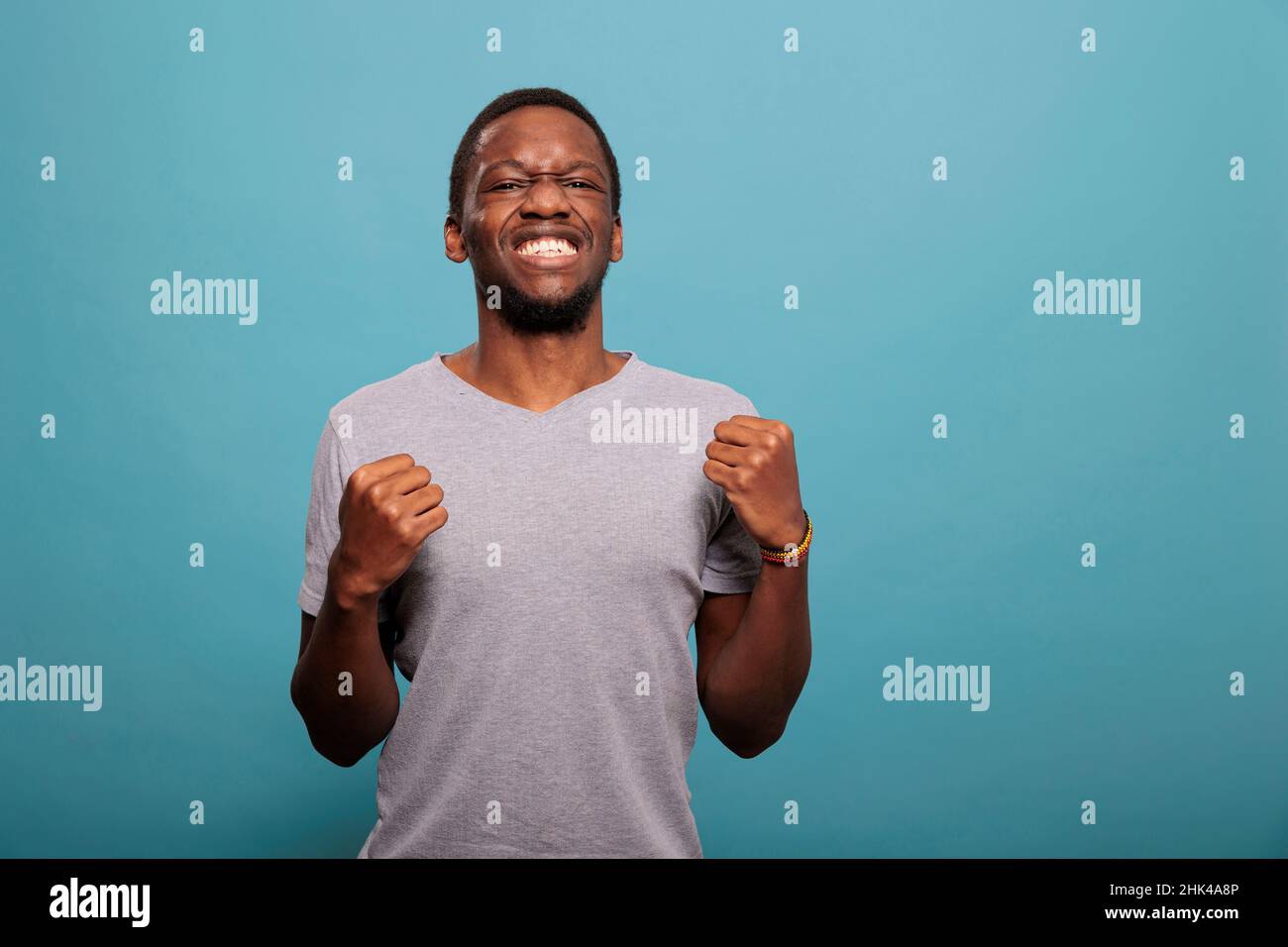 Joyful and excited guy celebrating big achievement with clenched fists ...