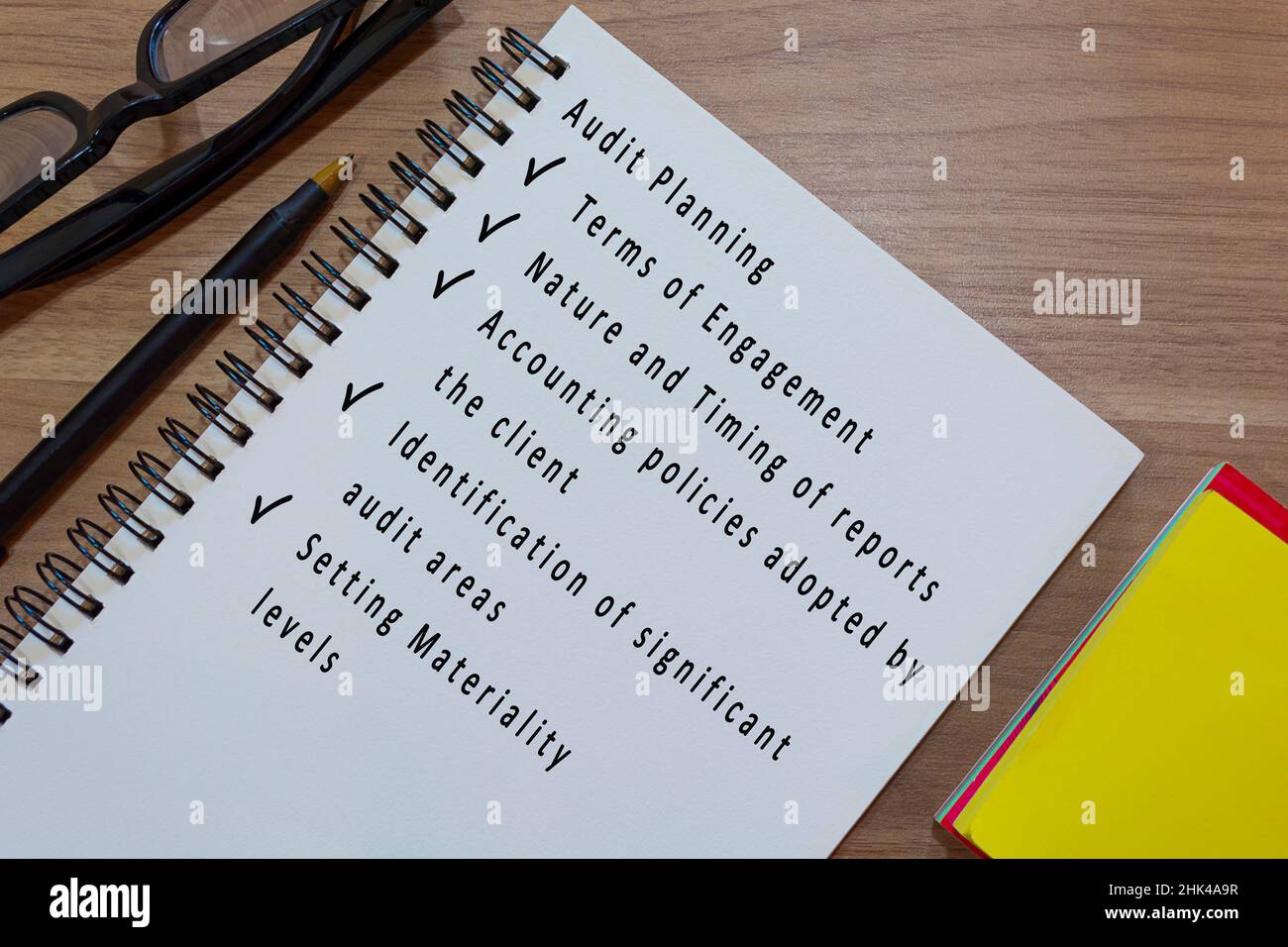 Text on notepad with yellow note and study glasses - Audit planning ...