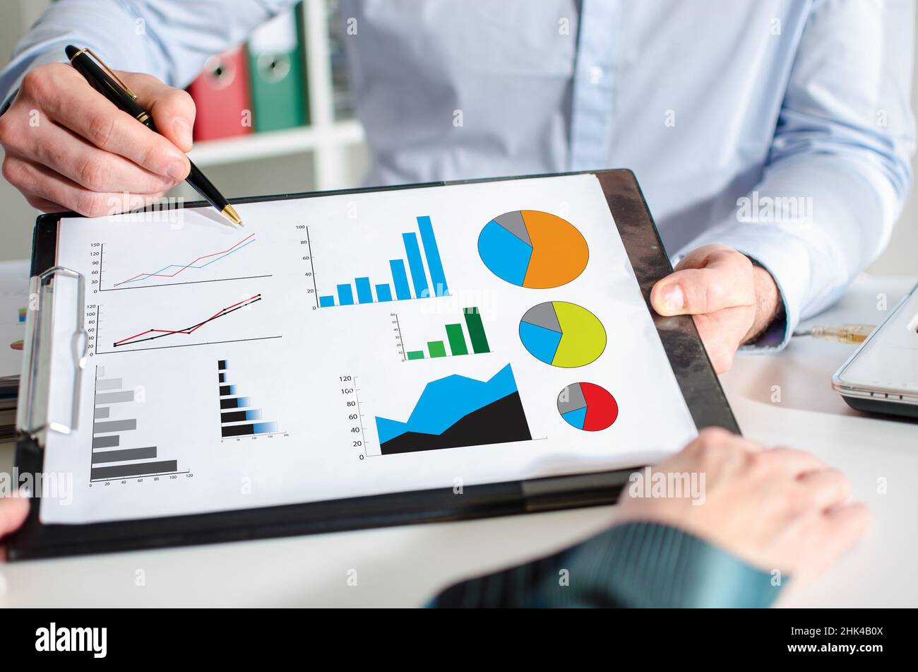 Businessman showing graphical analysis concept on a clipboard Stock ...