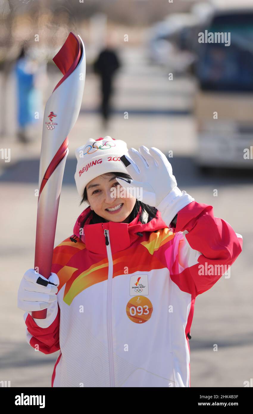 Beijing, China. 2nd Feb, 2022. Torch bearer Zhao Yanli runs with the torch during the Beijing ...