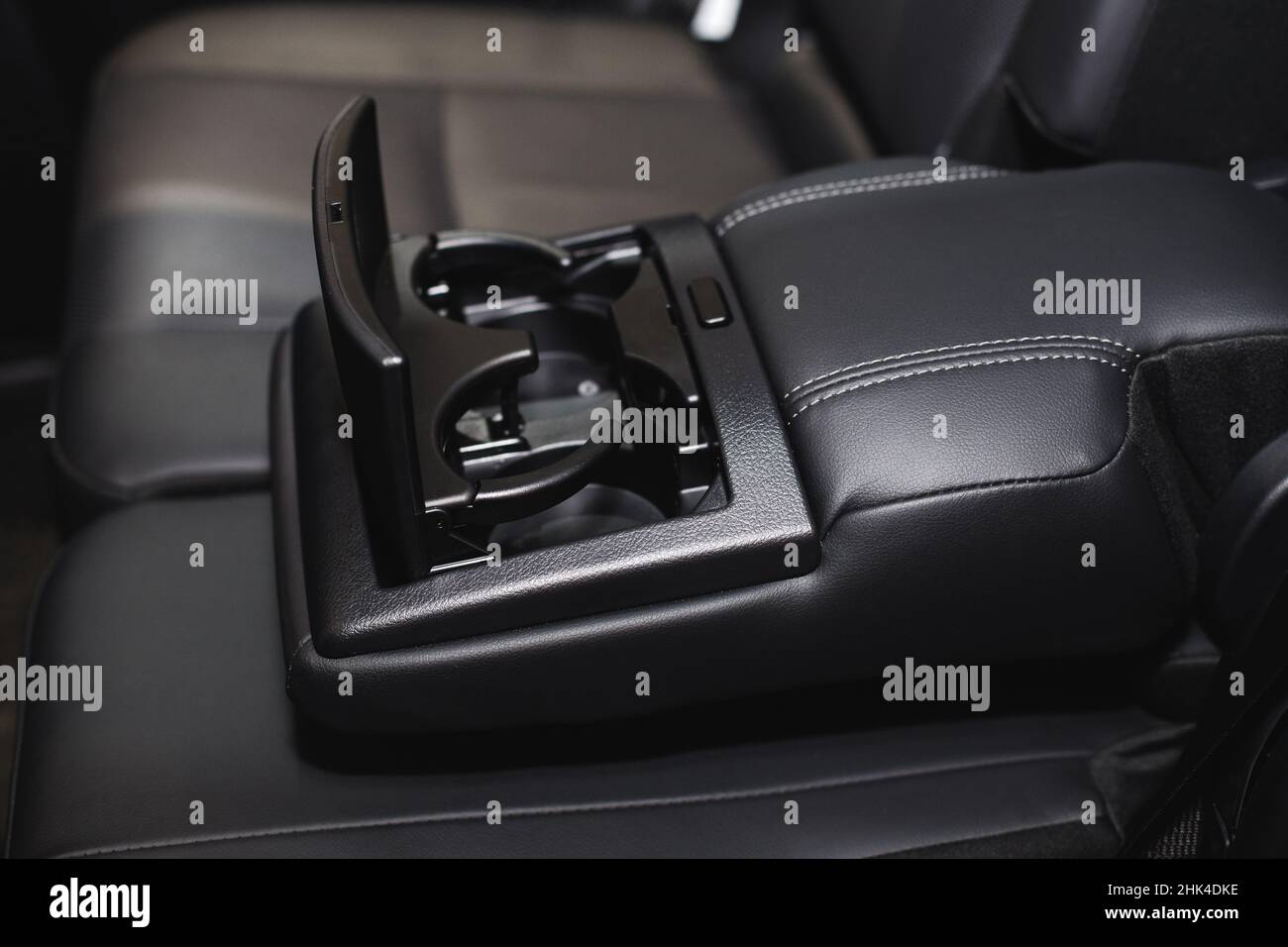 Luxury car rear seat cup holders with control panel Stock Photo - Alamy
