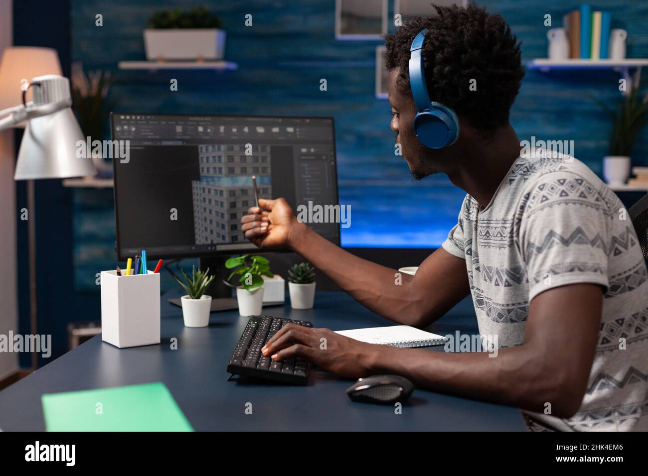 African american technical architect with headphones pointing at ...