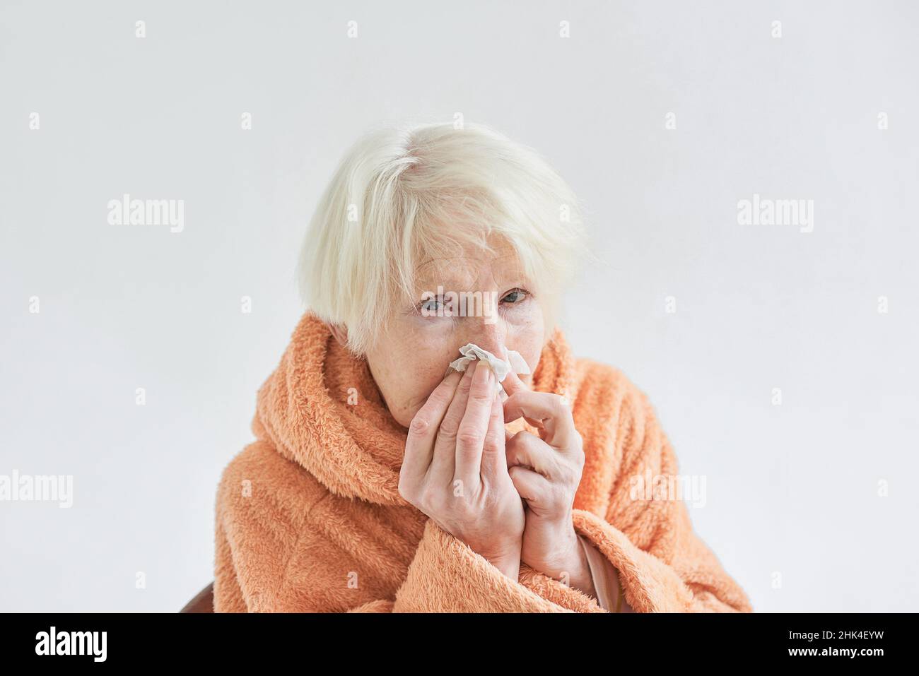 senior ill woman freezing cold at home. Health care, crisis, oldness ...