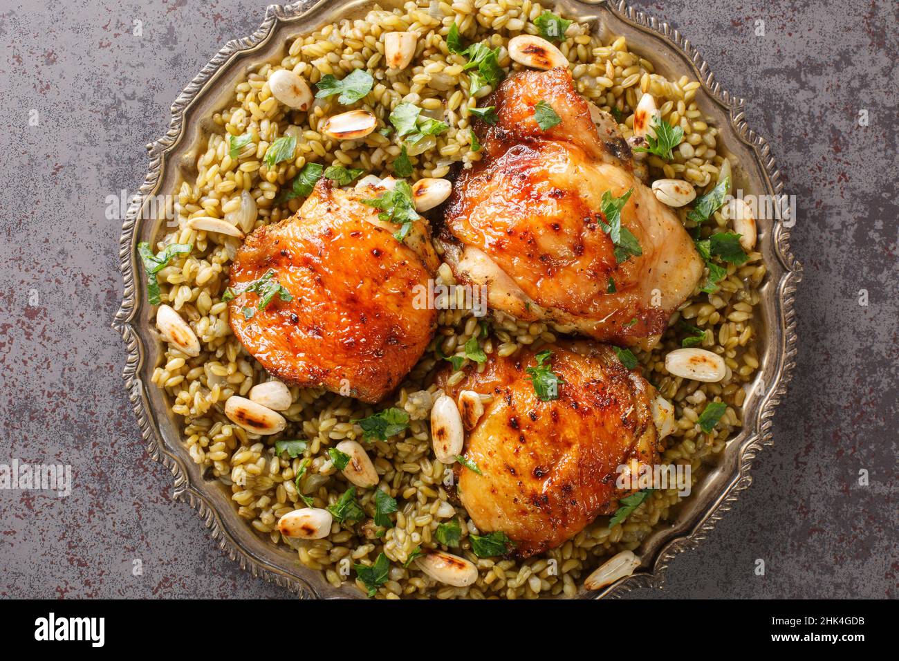 Plate of Traditional Syrian Freekeh with roasted chicken and almond ...