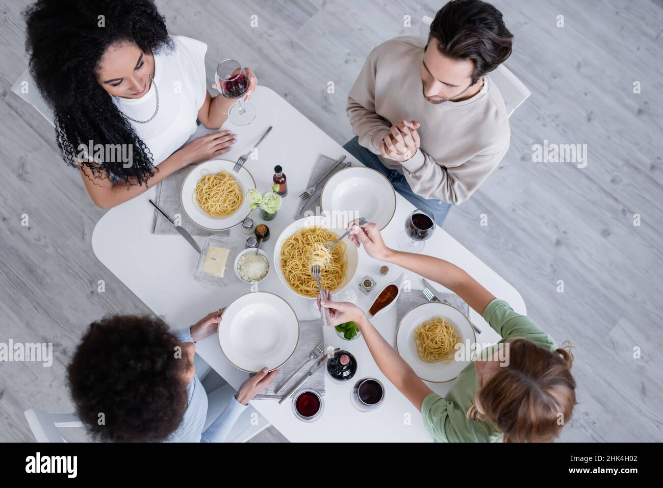 top view of multiethnic friends having lunch together Stock Photo - Alamy