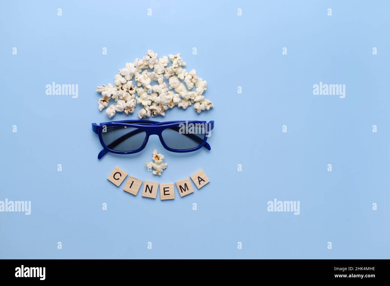 Pop Corn man face on blue background. Cinema concept. Top view flat lay ...
