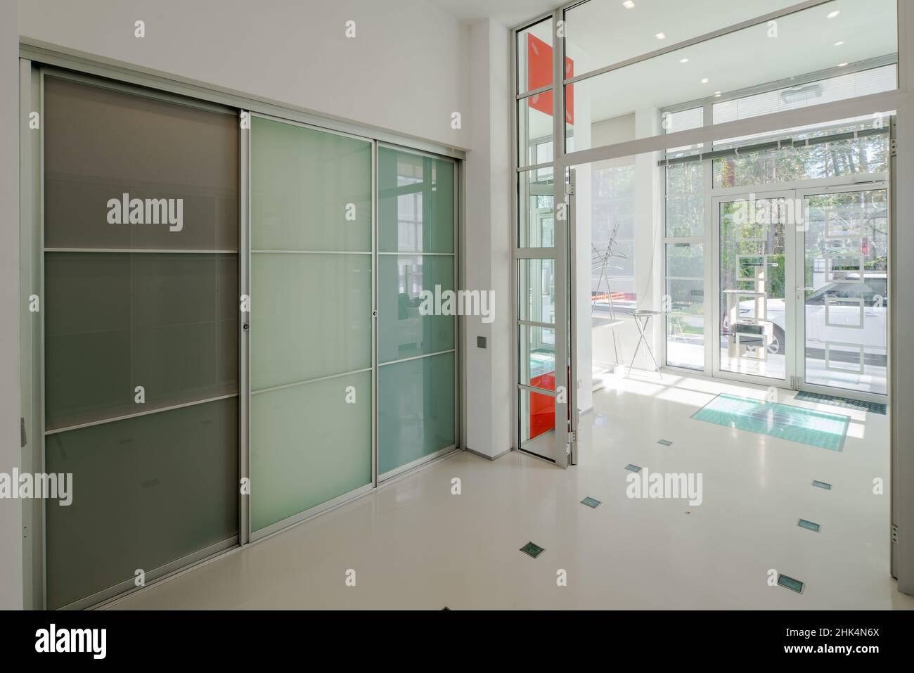Modern interior of spacious hall in luxury private house. Glass sliding ...