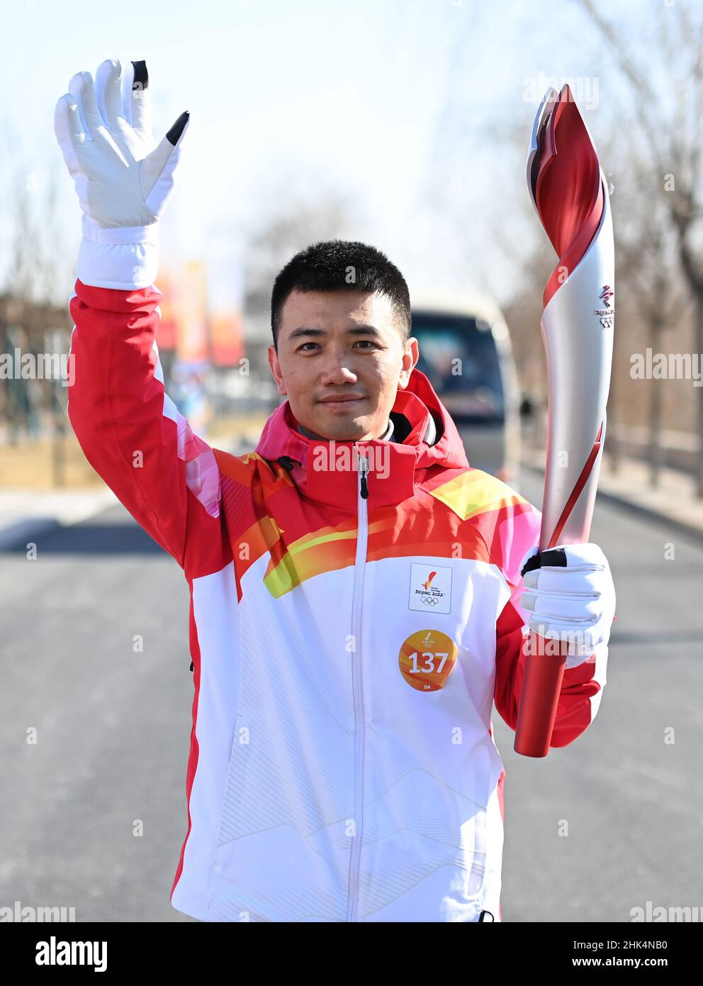 Beijing, China. 2nd Feb, 2022. Torch bearer Chen Lei runs with the torch during the Beijing 2022 ...