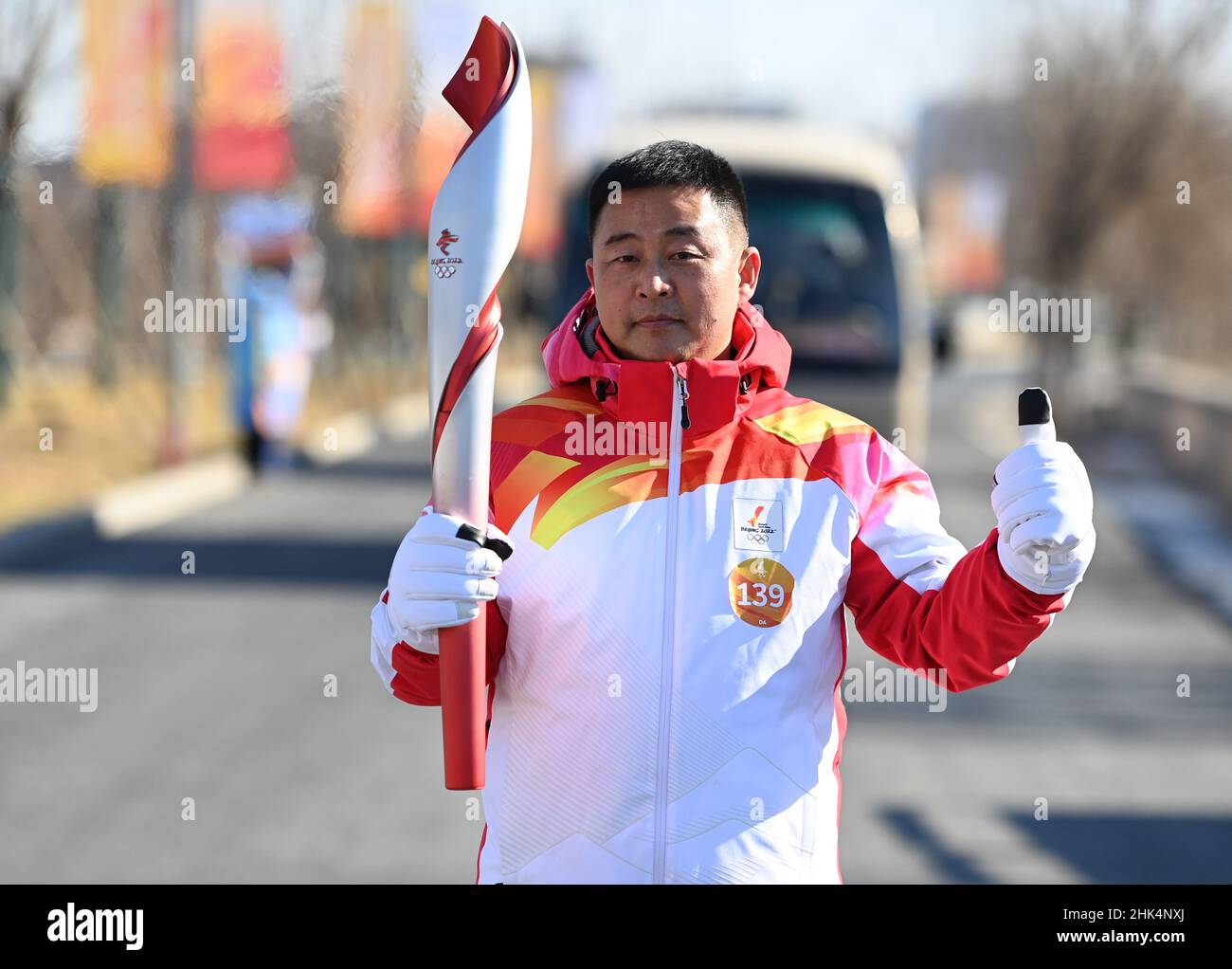 Beijing, China. 2nd Feb, 2022. Torch bearer Ouyang Chuan runs with the torch during the Beijing ...