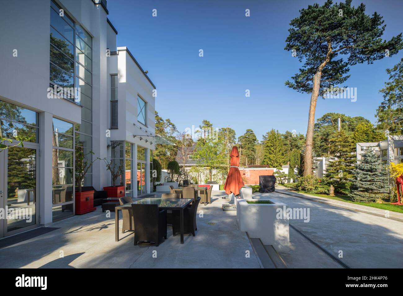 Modern exterior of luxury private house. Sunny summer day. Lounge zone ...