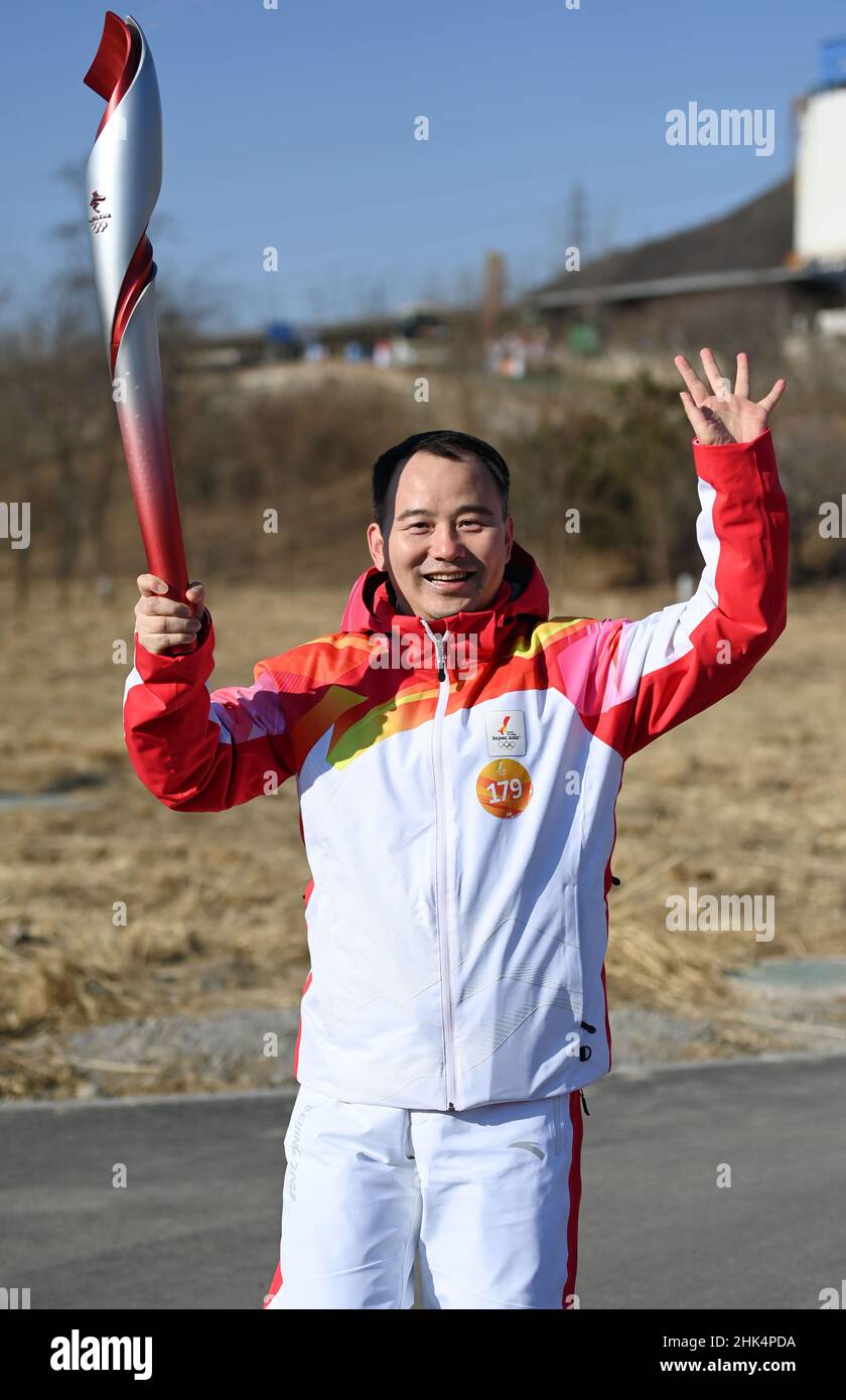 Beijing, China. 2nd Feb, 2022. Torch bearer Geng Chao runs with the ...