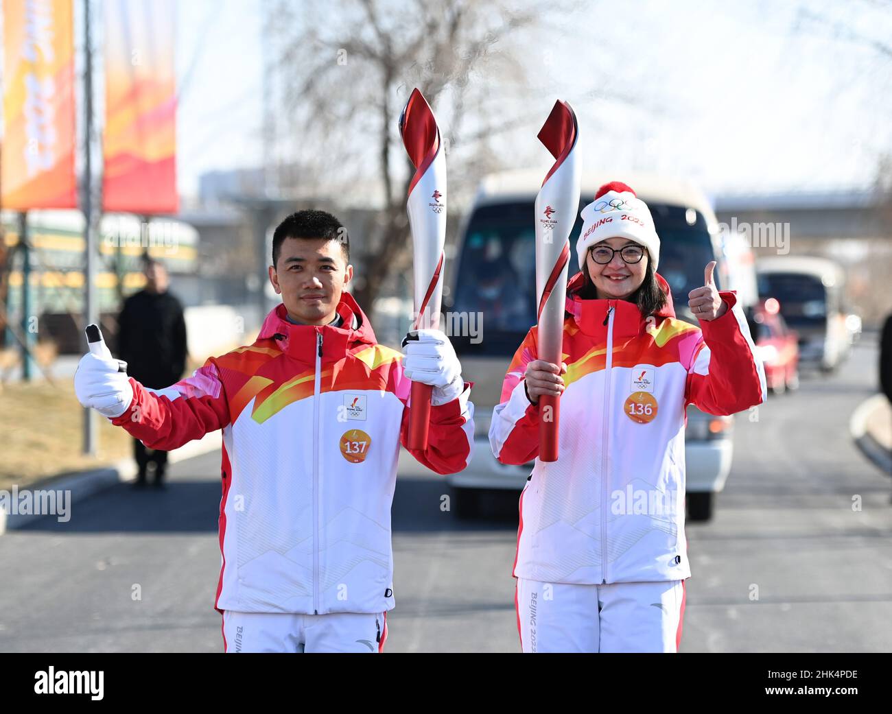 Beijing, China. 2nd Feb, 2022. Torch bearer Huang Xiangyan (R) and Chen ...