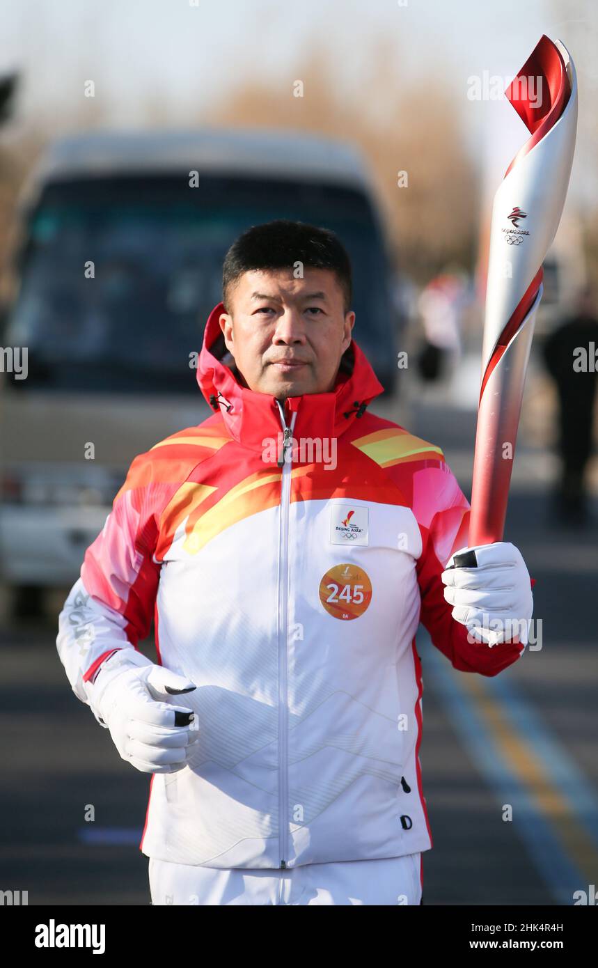 Beijing, China. 2nd Feb, 2022. Torch bearer Liu Chenhu runs with the ...