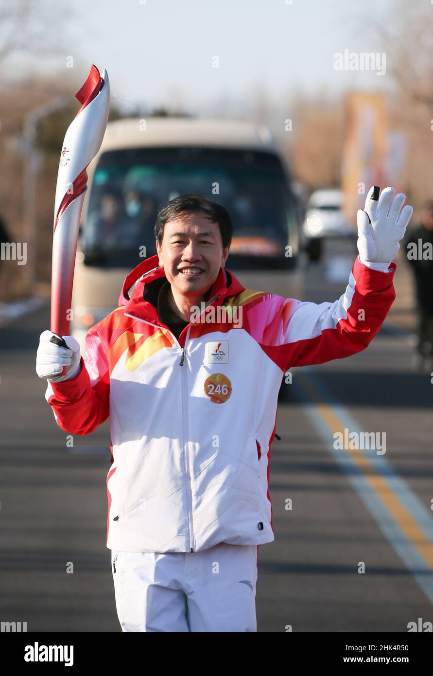 Beijing, China. 2nd Feb, 2022. Torch bearer Tang Wenwei runs with the torch during the Beijing ...