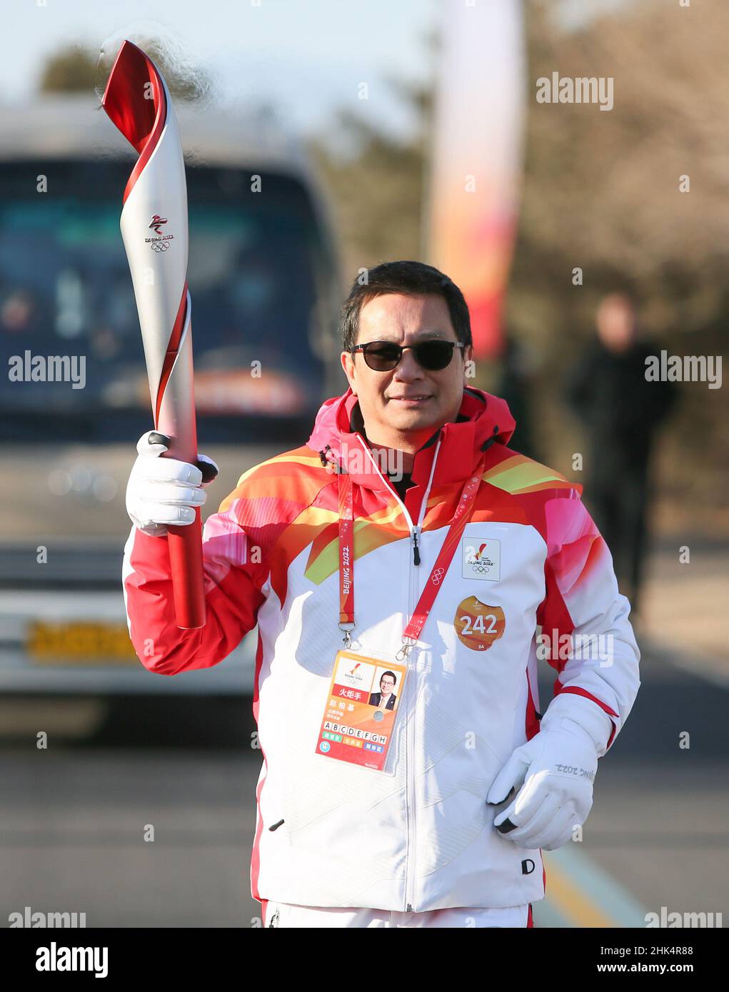 Beijing, China. 2nd Feb, 2022. Torch bearer Zhao Baiji runs with the torch during the Beijing ...