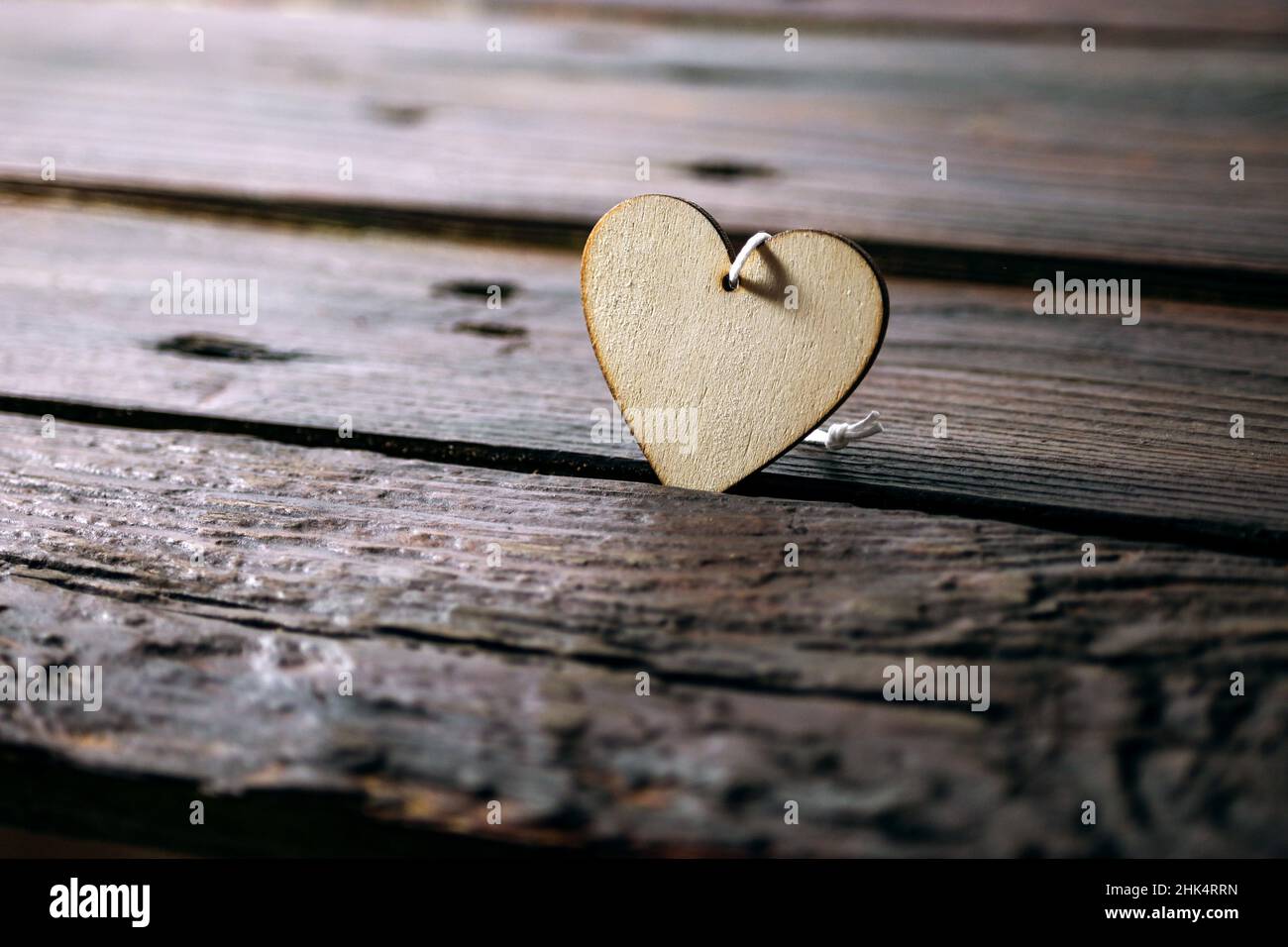 Light wooden heart shape on dark rustic planks, love concept for ...