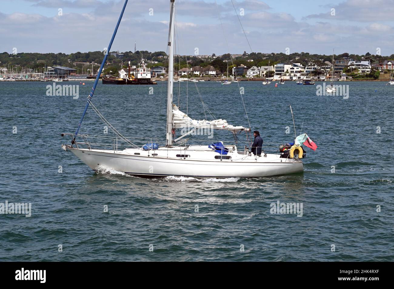 Poole Harbour, Dorset, England - June 2021: Person sailing a yacht in ...