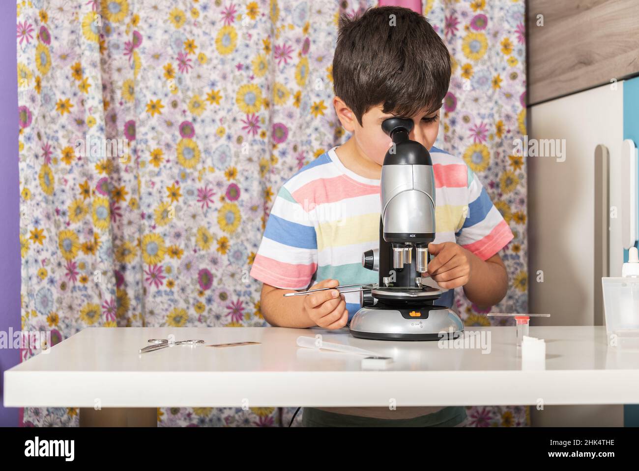 Little child caucasian boy looking through microscope in school Stock ...