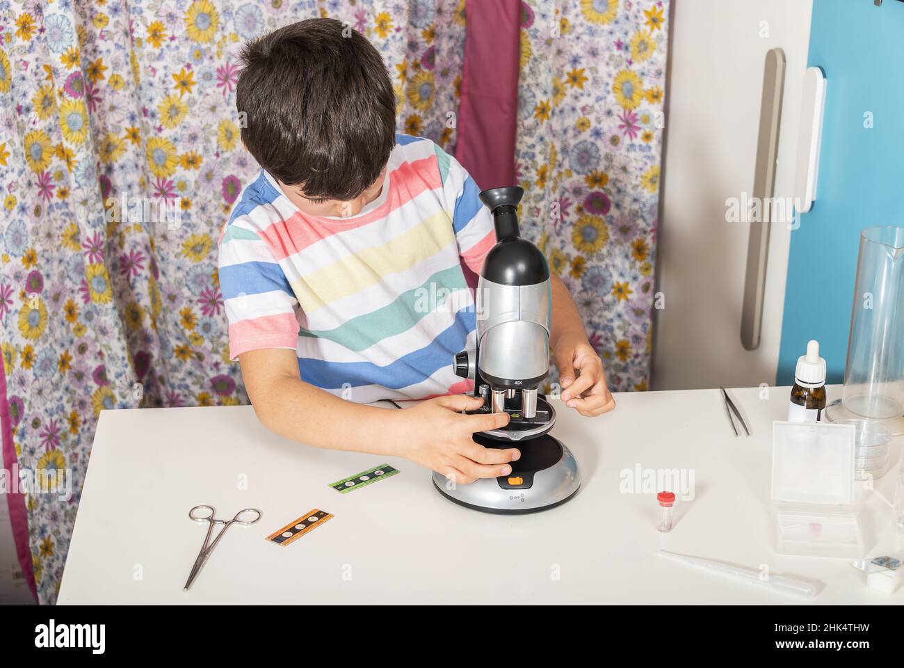 Little child caucasian boy looking through microscope in school Stock ...