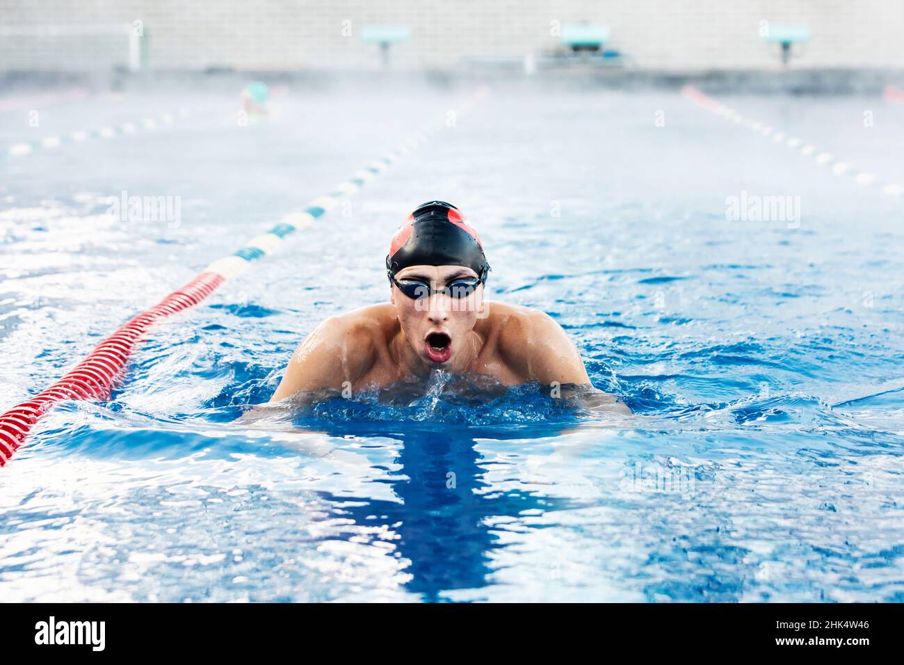 Professional male swimmer swimming in the pool Stock Photo - Alamy