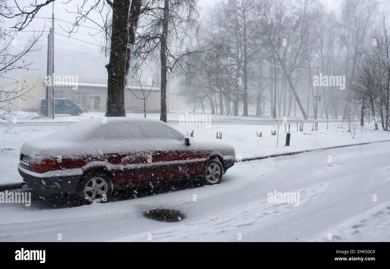 snowfall in the city in gloomy winter day Stock Photo - Alamy