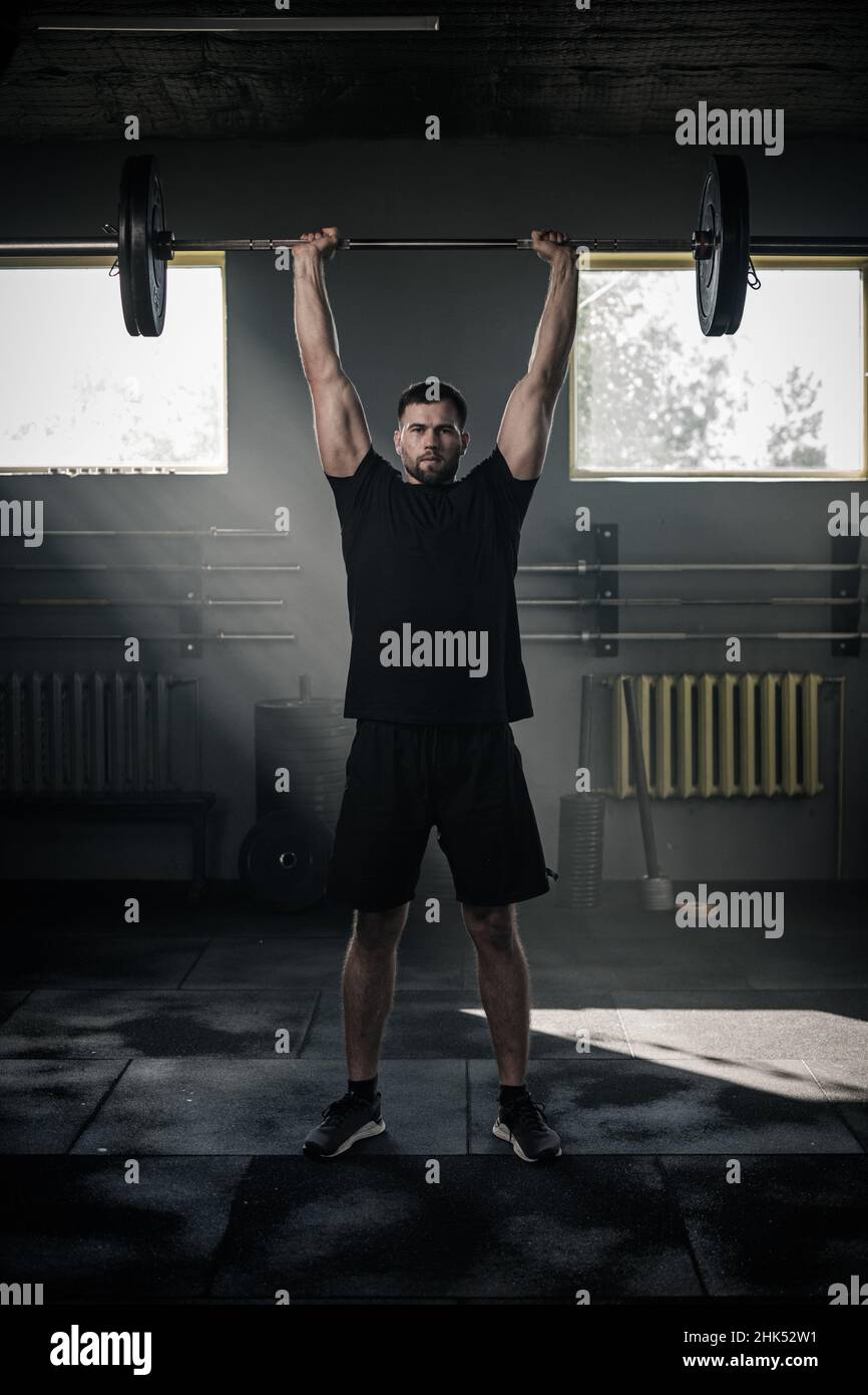 Sportsman Lift Heavy Barbell and Look at Camera Stock Photo - Alamy