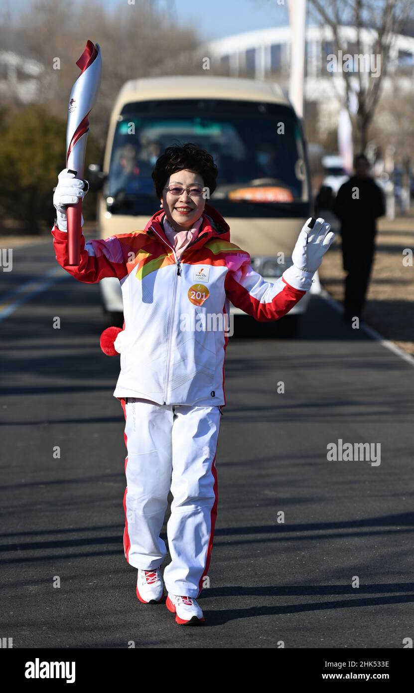 Beijing, China. 2nd Feb, 2022. Torch bearer He Aifang runs with the ...