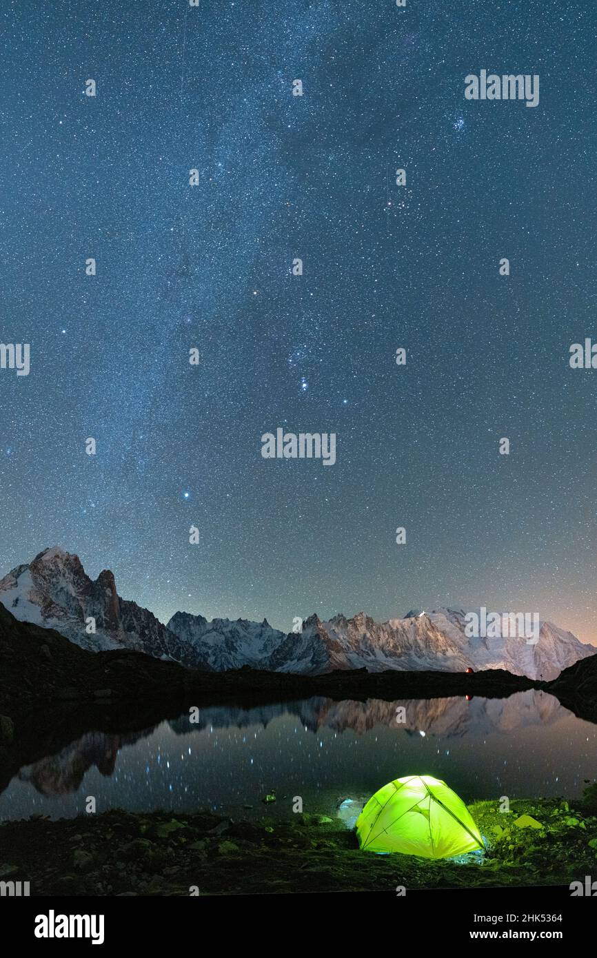 Milky Way glowing over Mont Blanc massif covered with snow and camping ...