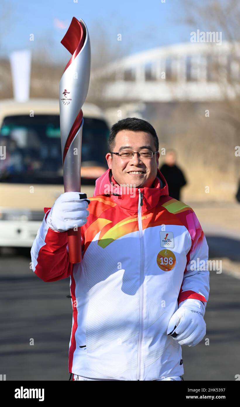 Beijing, China. 2nd Feb, 2022. Torch bearer Yang Muzi runs with the torch during the Beijing ...