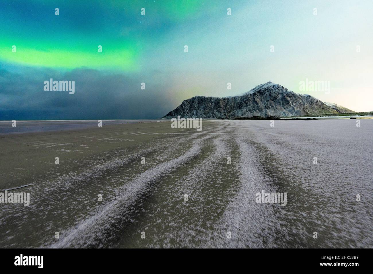 Frozen sand of Skagsanden beach under northern lights (aurora borealis ...