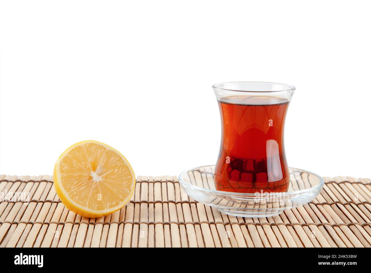 Glass of turkish tea and lemon on white background Stock Photo - Alamy
