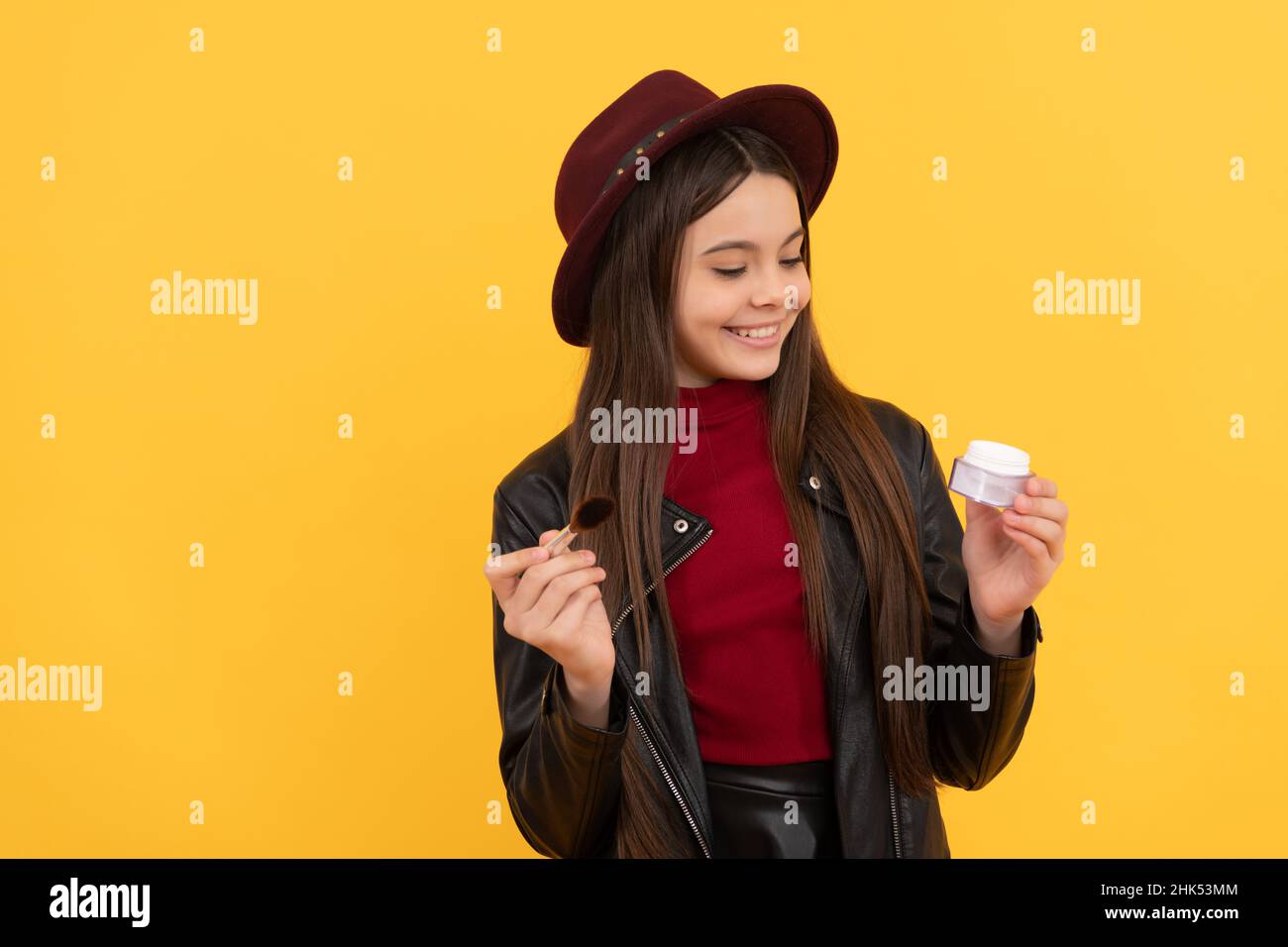 presenting female cosmetic product. happy child use face powder. teen ...